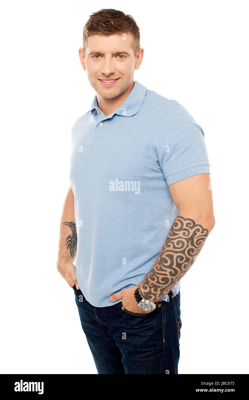 Handsome smiling chap posing casually. Hands in jeans pocket Stock ...