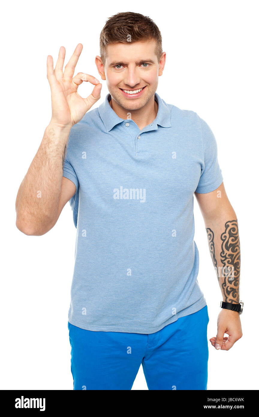 Smart smiling man gesturing okay sign. Tattoo engraved on hand Stock ...