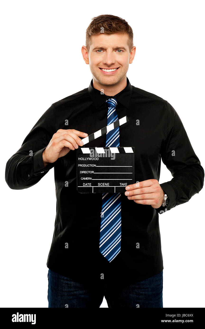 Young smart guy holding clapboard. Its showtime Stock Photo - Alamy
