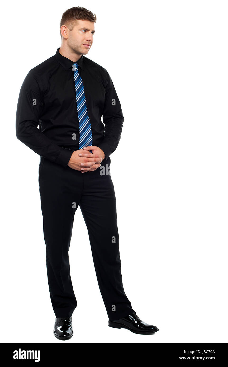 Thoughtful young serious businessman. Full length portrait Stock Photo ...
