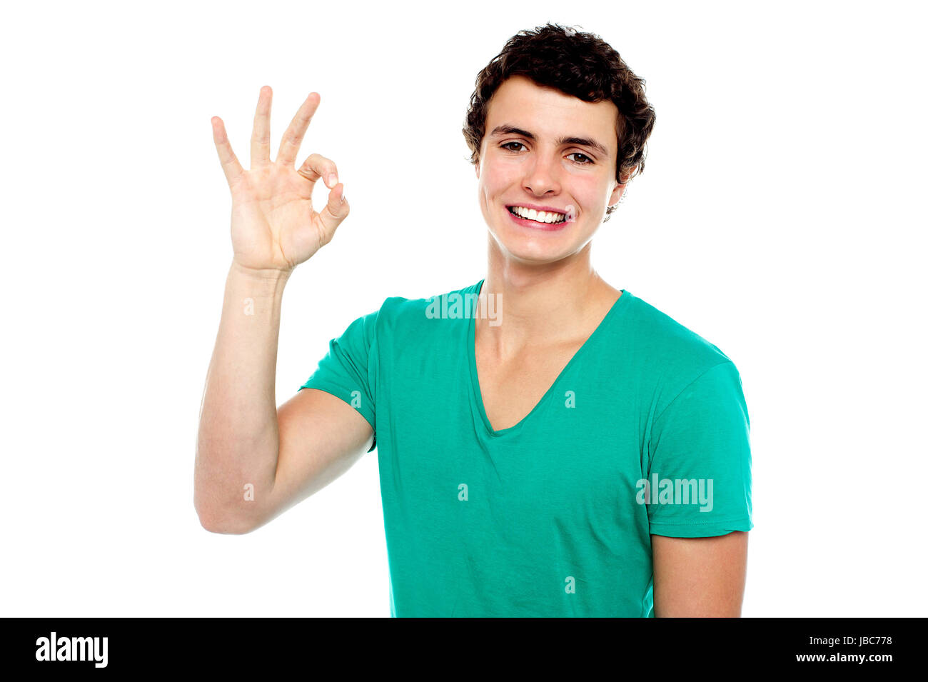 Cheerful young boy showing perfect sign isolated on white background ...