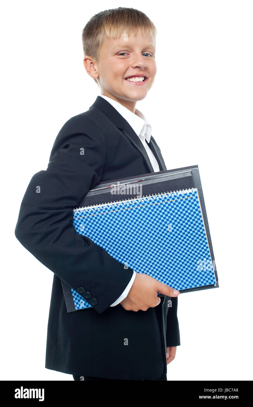 Cheerful little boy holding business files posing confidently Stock ...