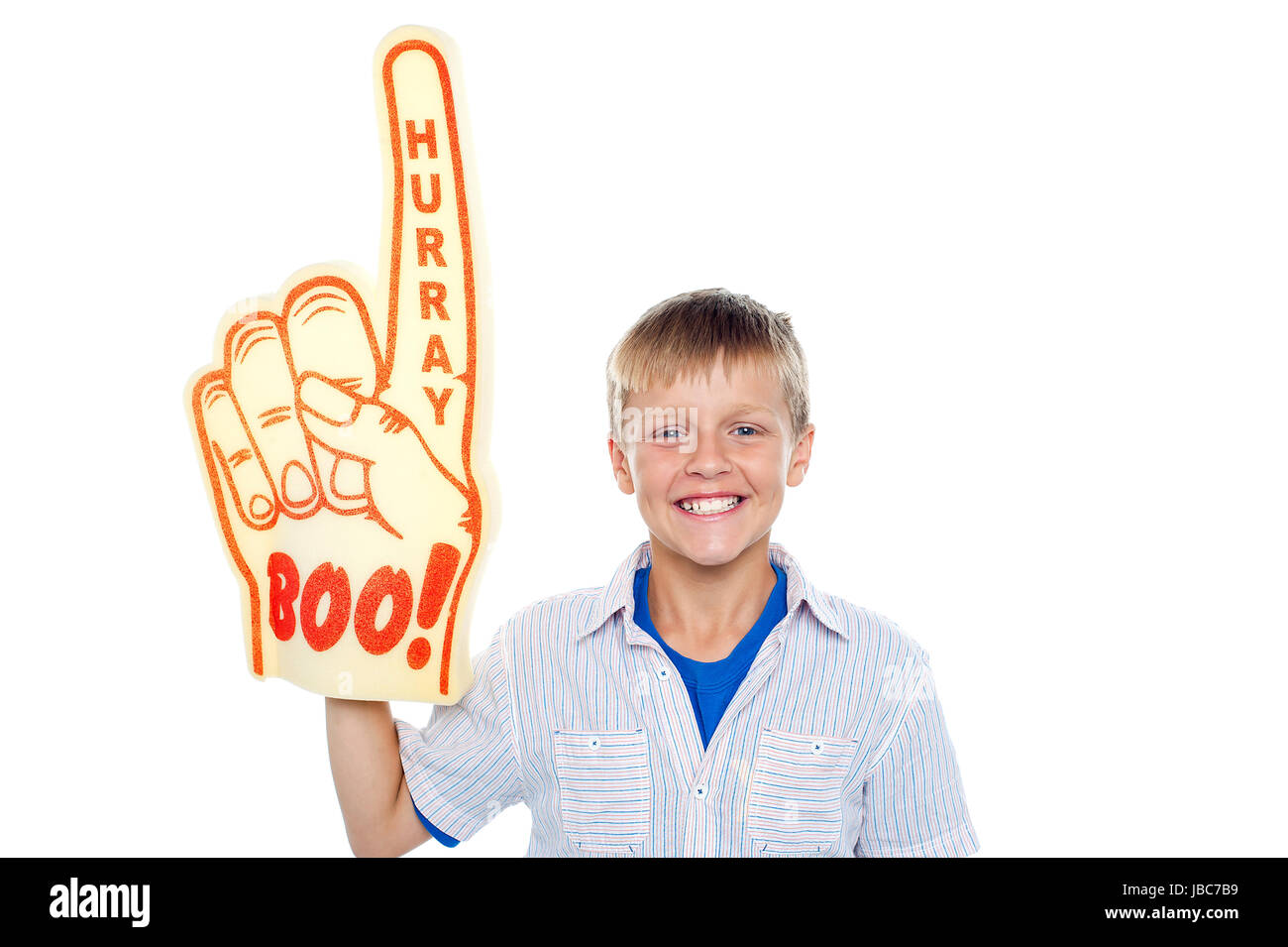 Handsome boy with a hurray boo foam hand pointing skywards on isolated ...