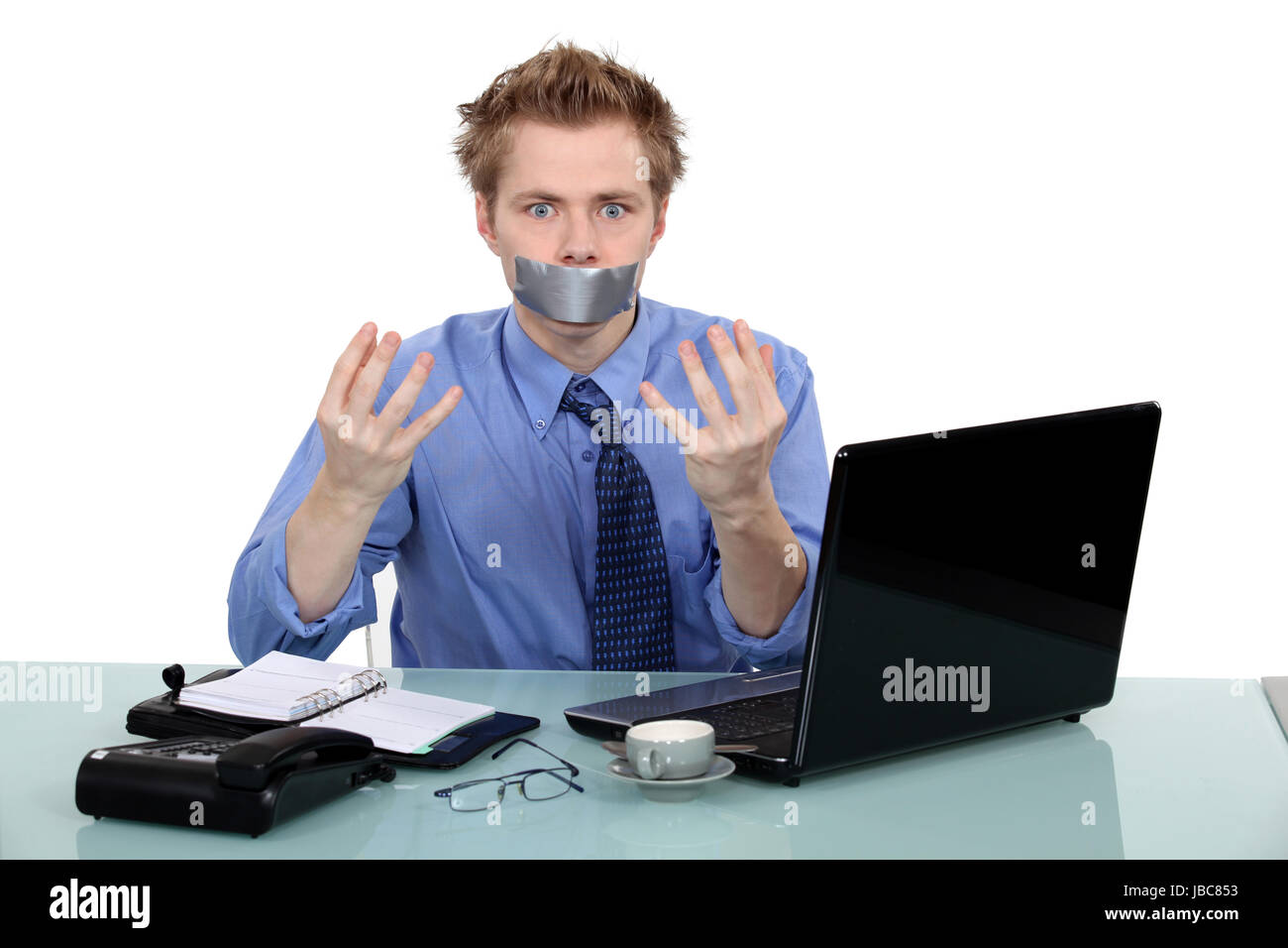 Office worker with his mouth taped shut Stock Photo - Alamy