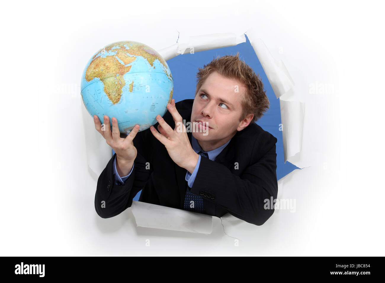 Man holding globe Stock Photo - Alamy
