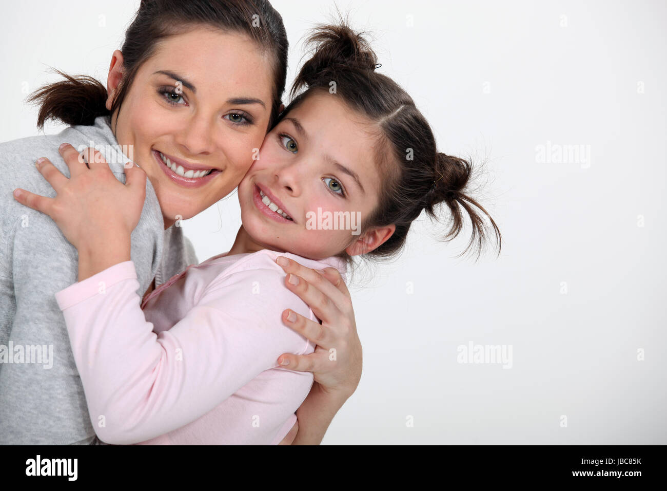 Mother hugging her daughter Stock Photo - Alamy