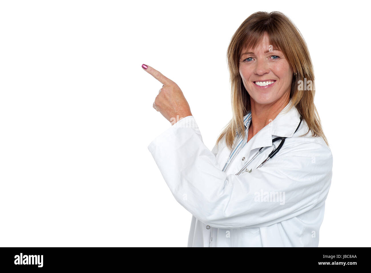Experienced female doctor standing sideways and pointing away Stock ...