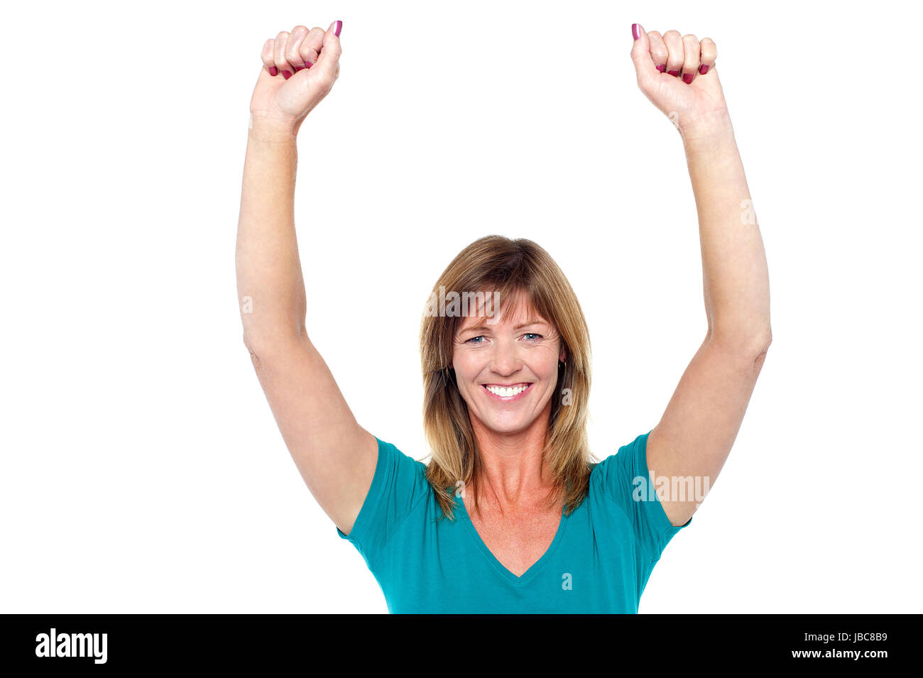 Jubilant middle aged lady on white background celebrating her victory ...