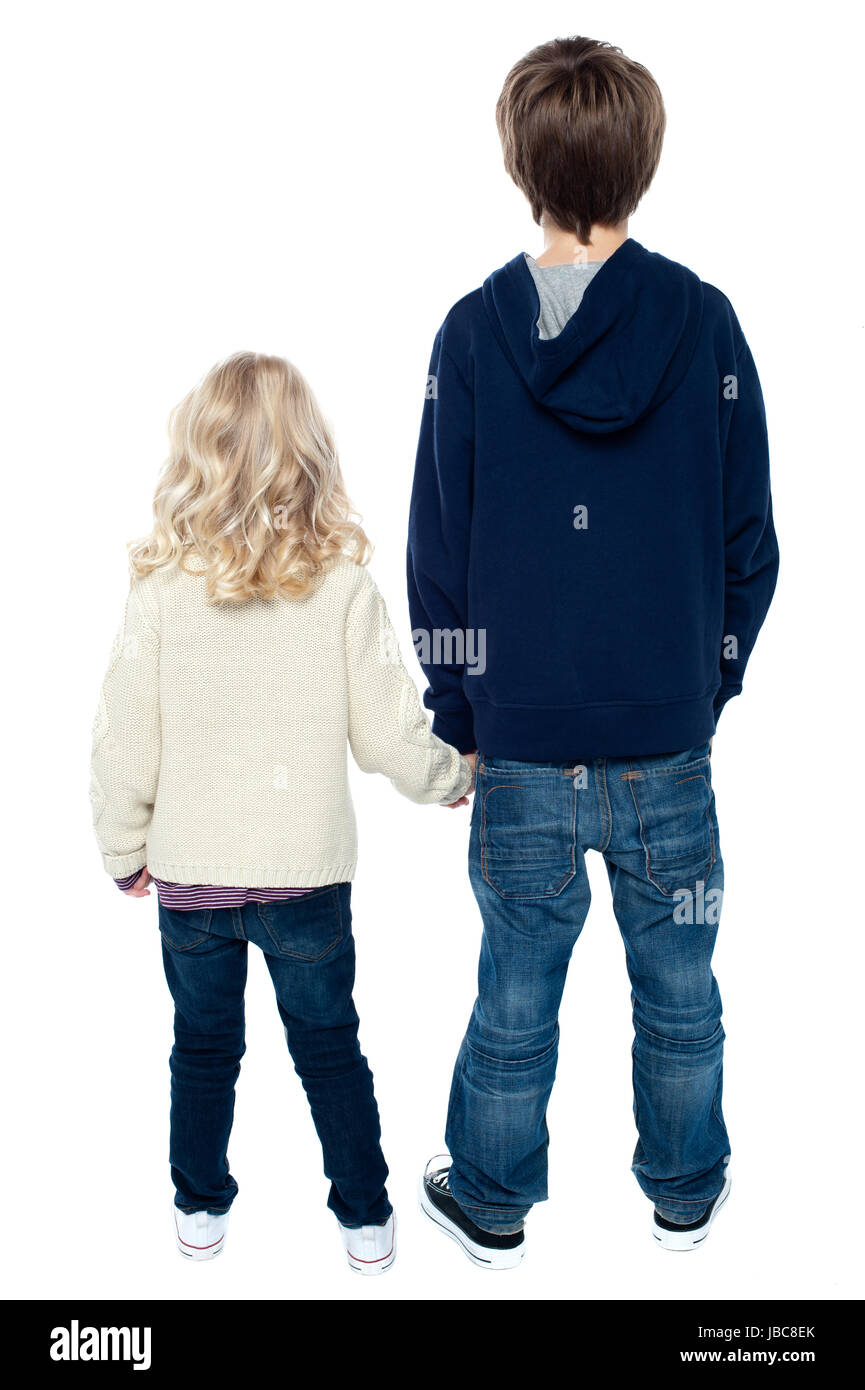 Rear view of two little kids looking in opposite direction Stock Photo ...