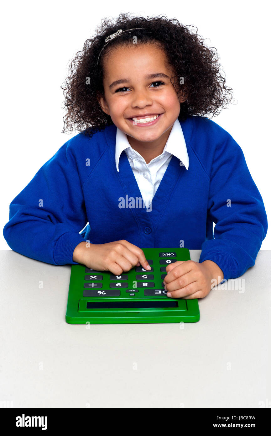 African elementary school kid using big green calculator. Education and ...