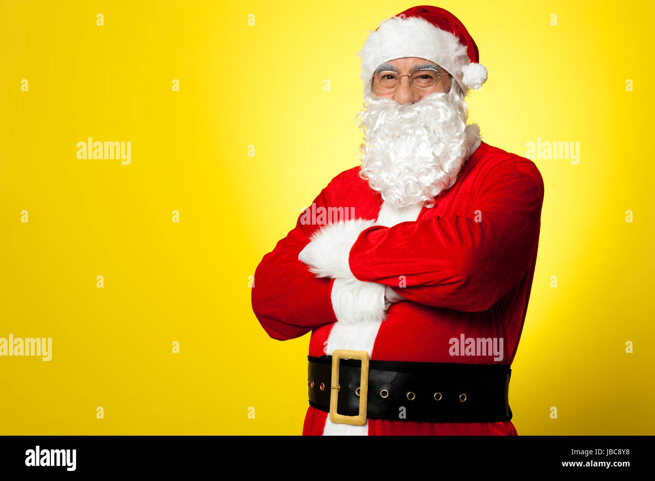 Saint Nick posing confidently against yellow background, arms folded ...