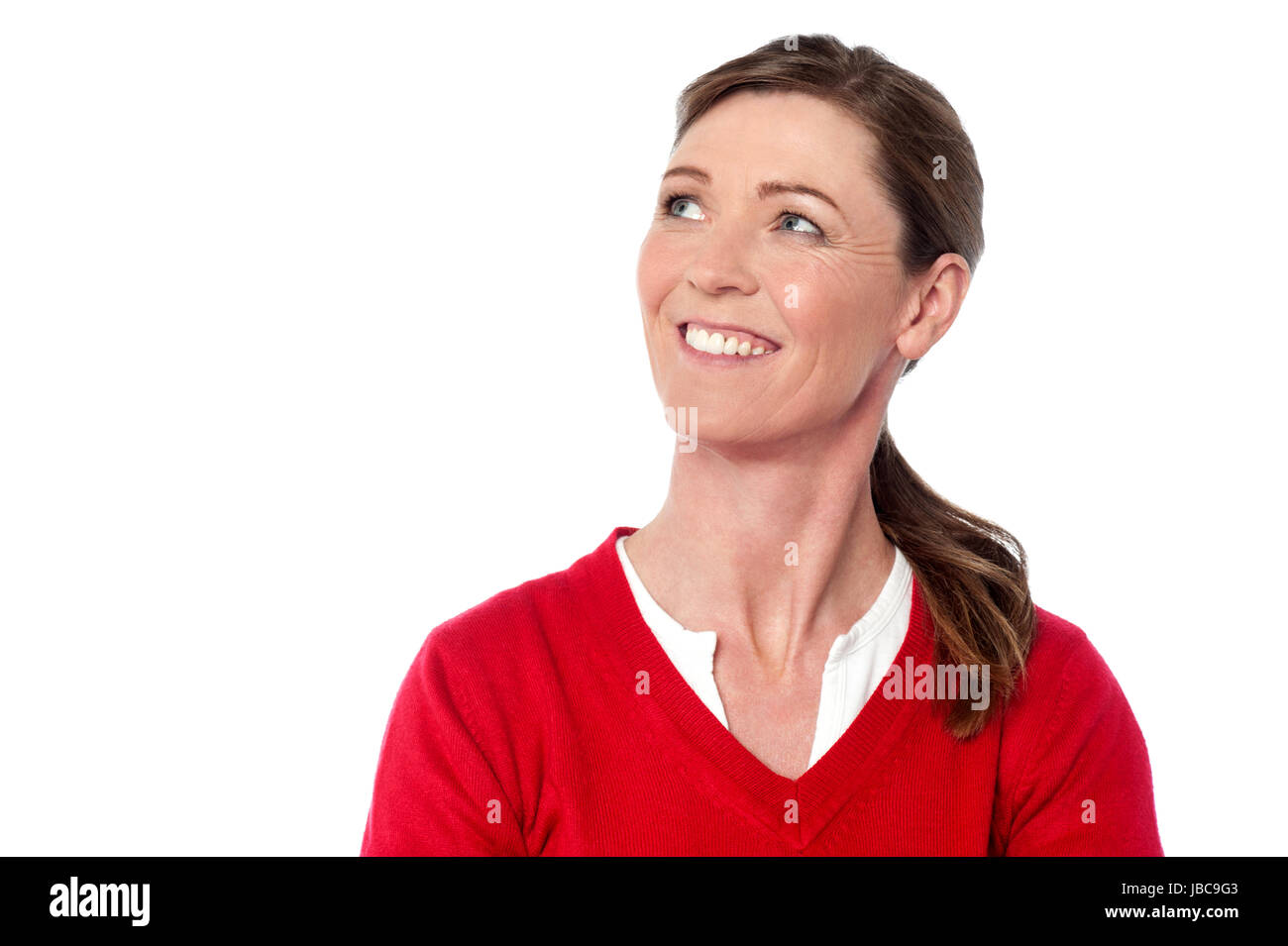 Middle aged woman looking away and smiling against white Stock Photo ...