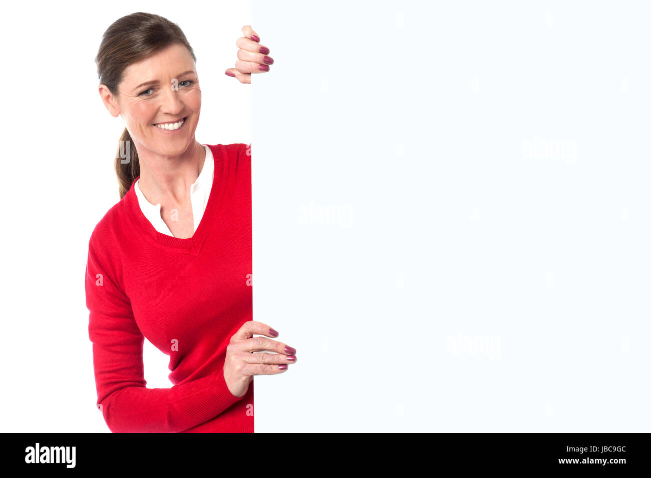 Charming lady holding a blank white ad board Stock Photo - Alamy