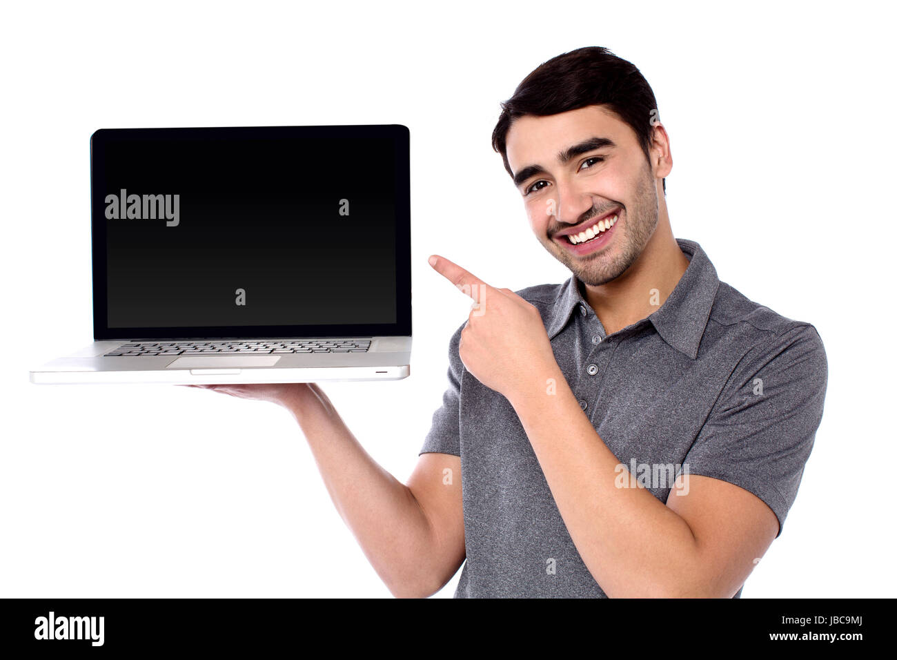 Young man showing his brand new laptop to you Stock Photo - Alamy