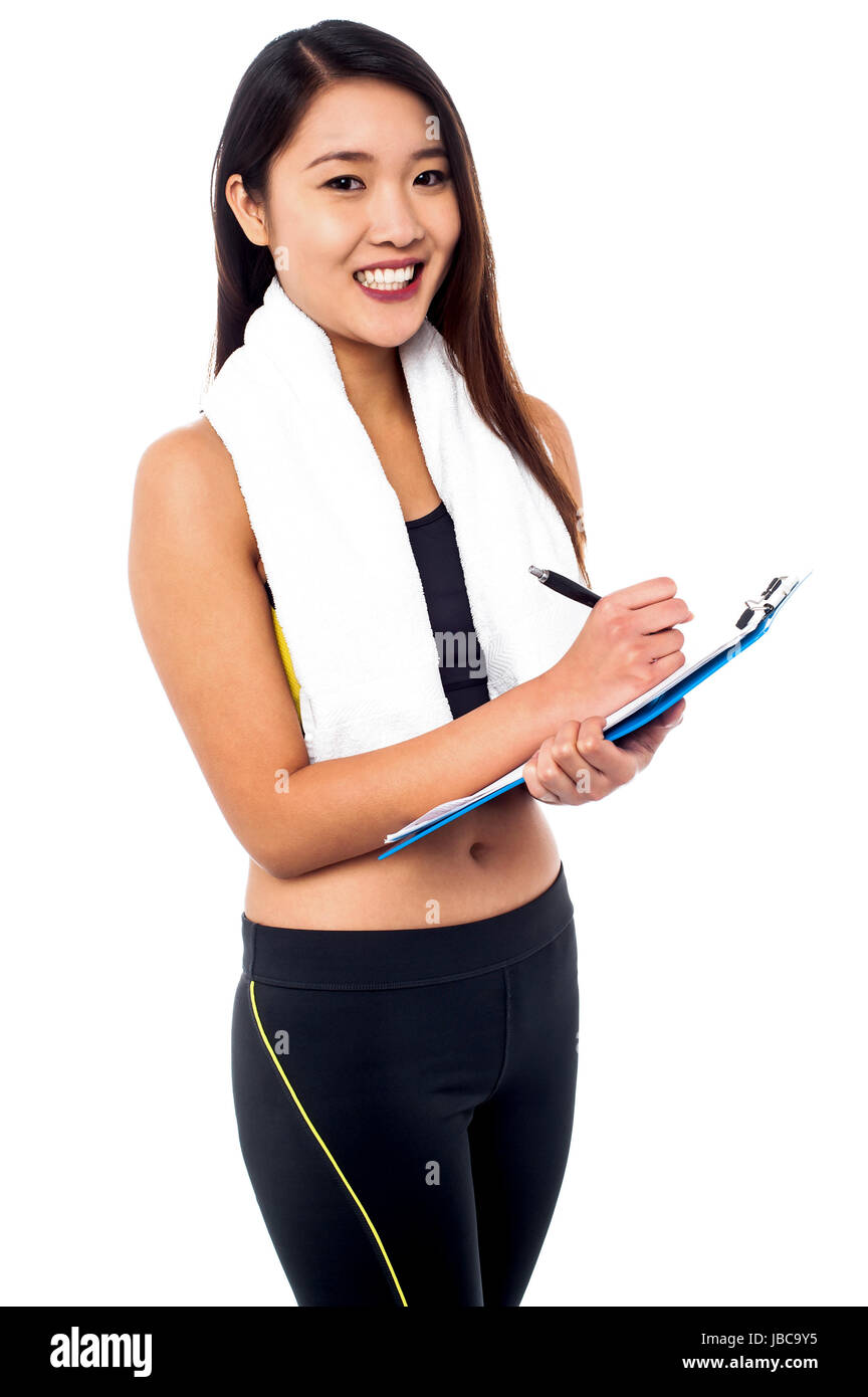 Young slim gym trainer preparing standard diet plan Stock Photo - Alamy