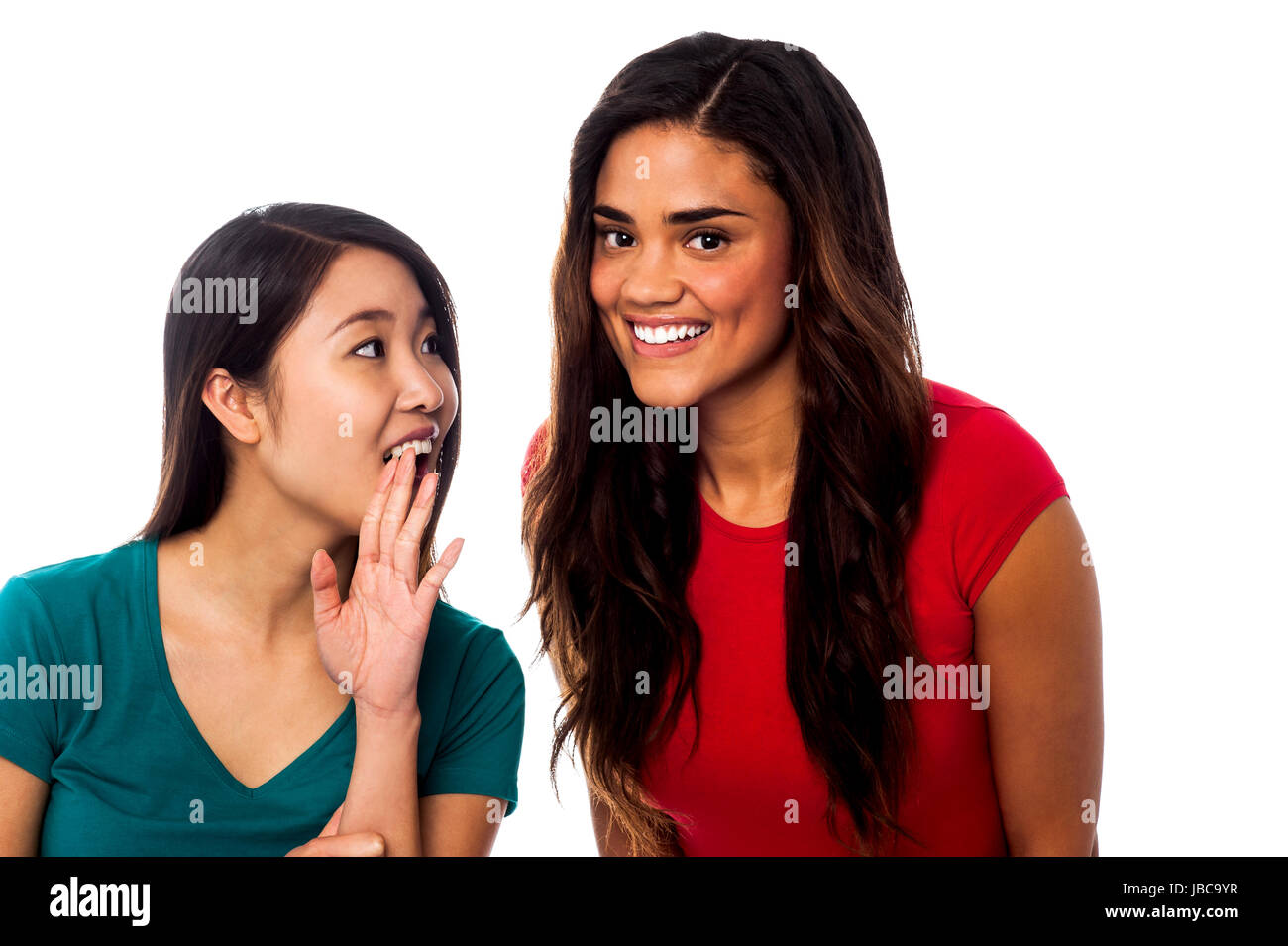 Friends sharing secret and having fun Stock Photo - Alamy
