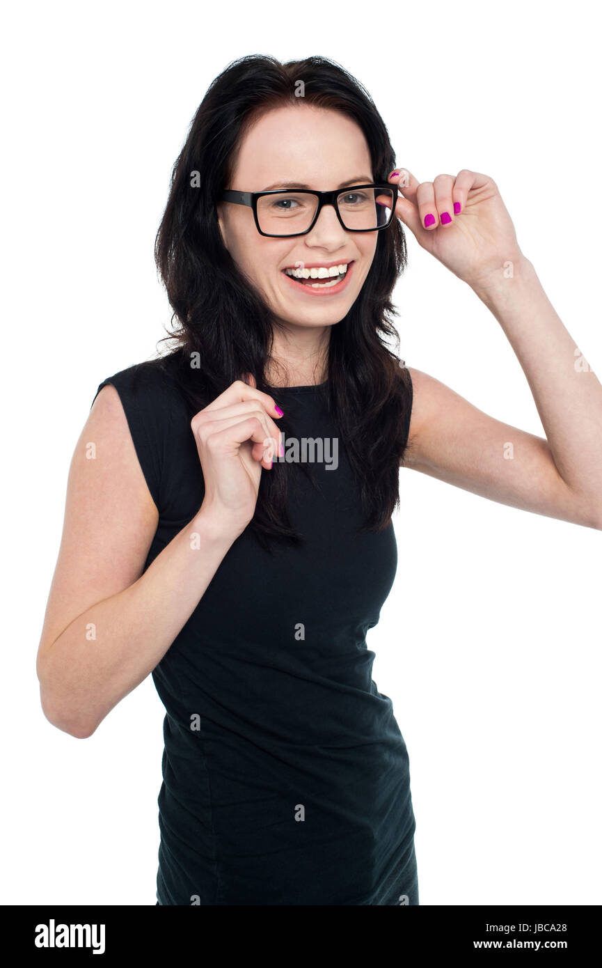 Beautiful young woman adjusting her spectacles Stock Photo - Alamy