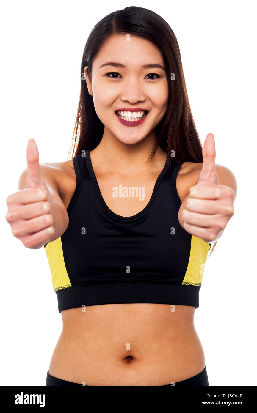 Fit chinese girl showing double thumbs up Stock Photo - Alamy