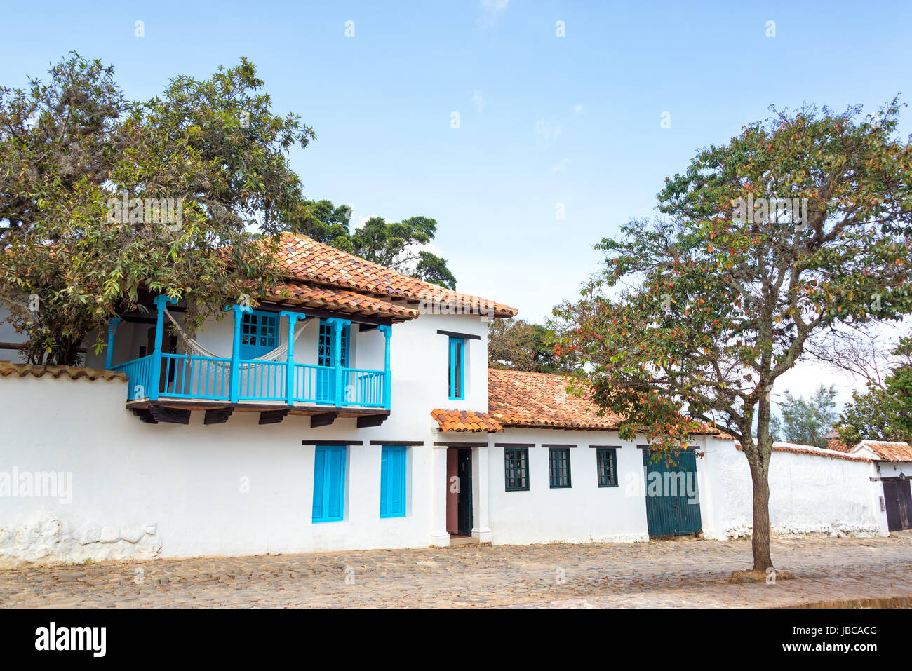 White colonial architecture with a light blue balcony in Villa de Leyva ...