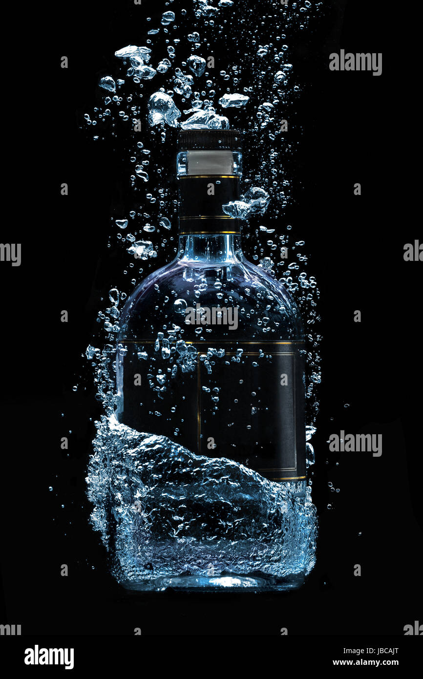 A photo of dipping luxury alcohol bottle Stock Photo - Alamy