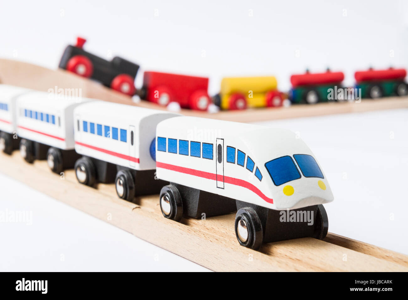 two wooden toy trains on railway isolated on white background Stock ...