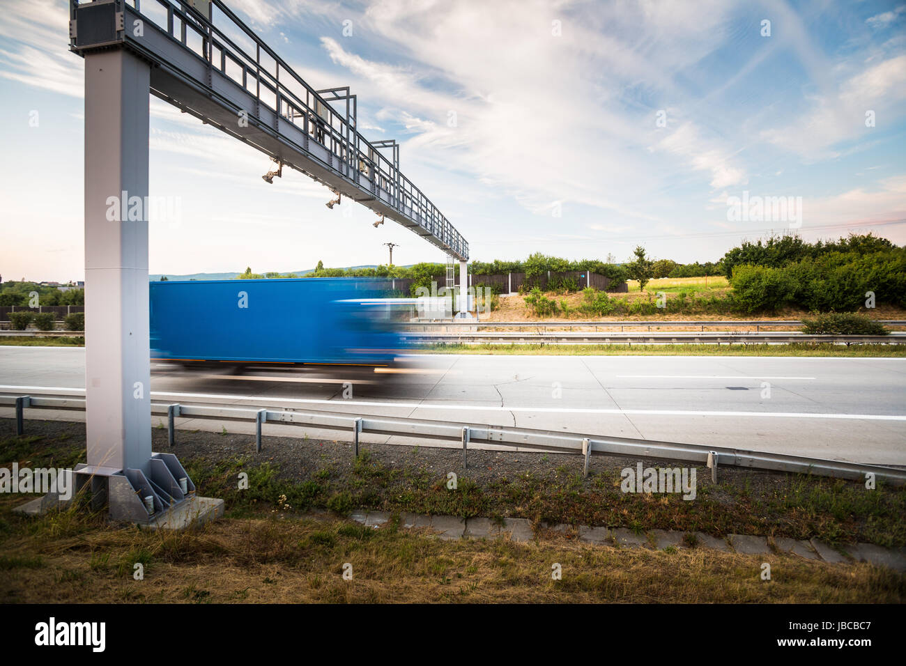 truck passing through a toll gate on a highway (motion blurred image ...