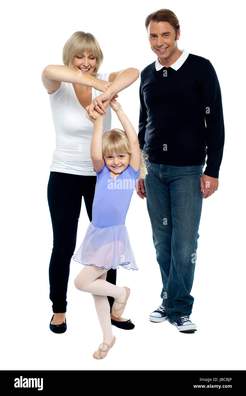 Young parents helping their daughter dance Stock Photo - Alamy
