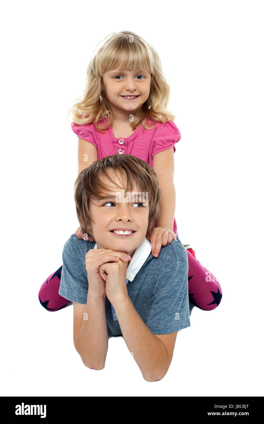 Cute girl kid sitting on her brother's back Stock Photo - Alamy