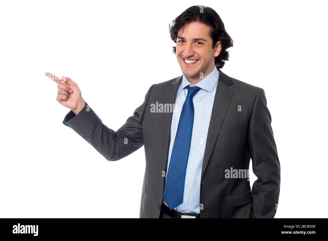 Smart male executive pointing towards copy space area Stock Photo - Alamy