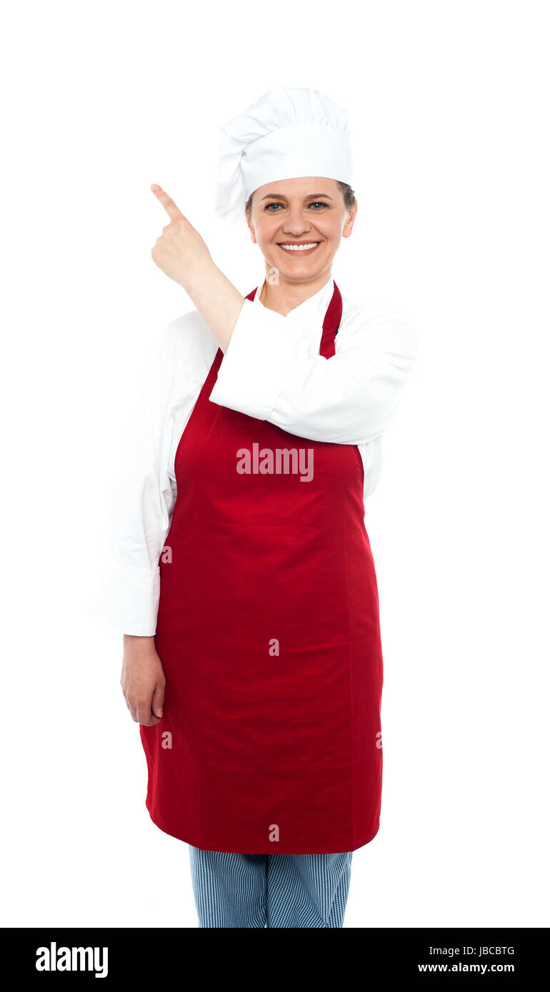 Female chef with red apron pointing copyspace Stock Photo - Alamy