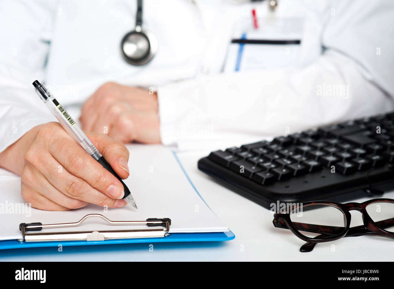 Physician writing prescription-cropped image Stock Photo - Alamy