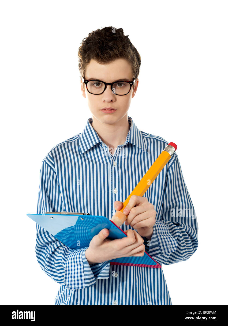Serious faced boy writing with big yellow pencil Stock Photo - Alamy