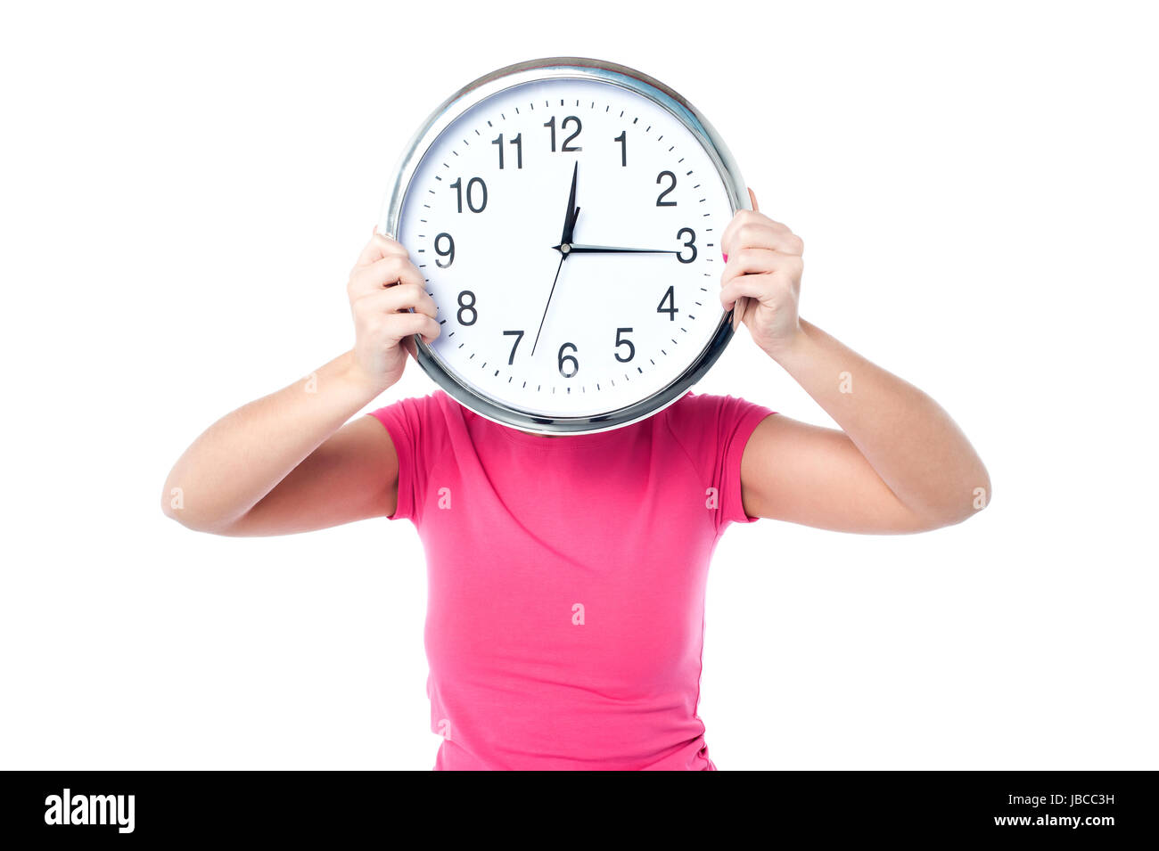 Young girl hiding her face behind wall clock Stock Photo - Alamy
