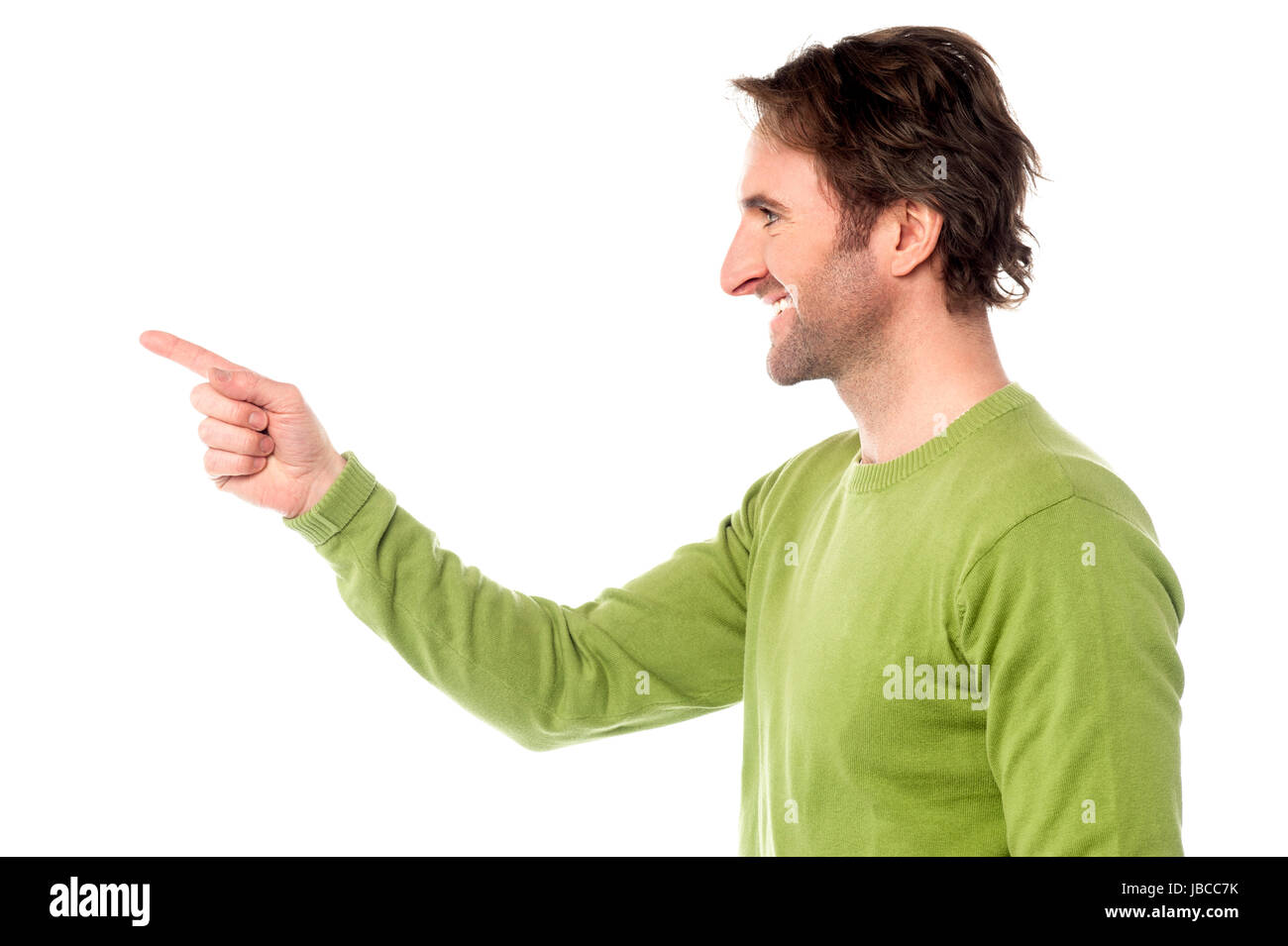 Smart young guy pointing at something Stock Photo - Alamy