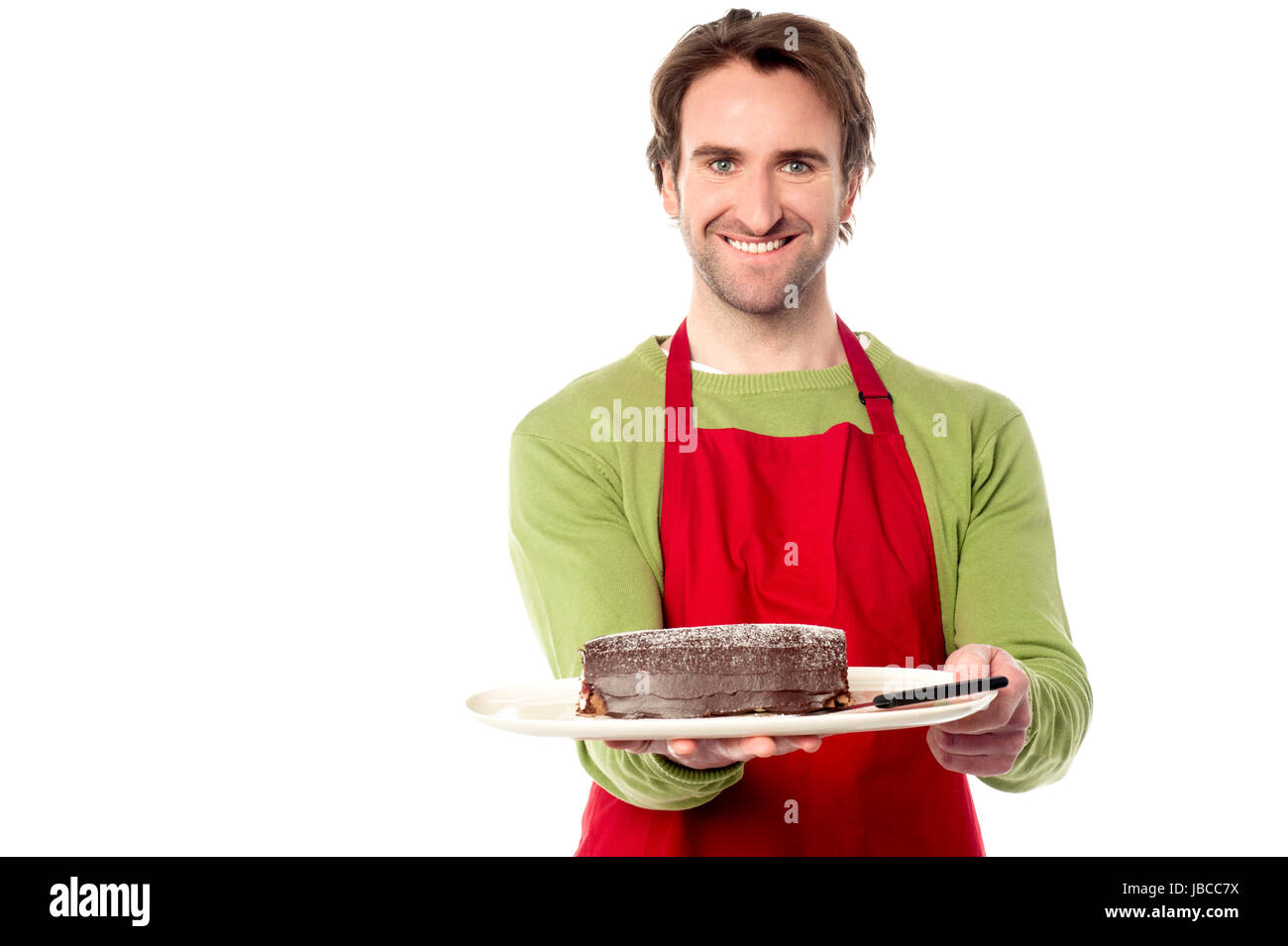 Young male chef presenting birthday cake Stock Photo - Alamy