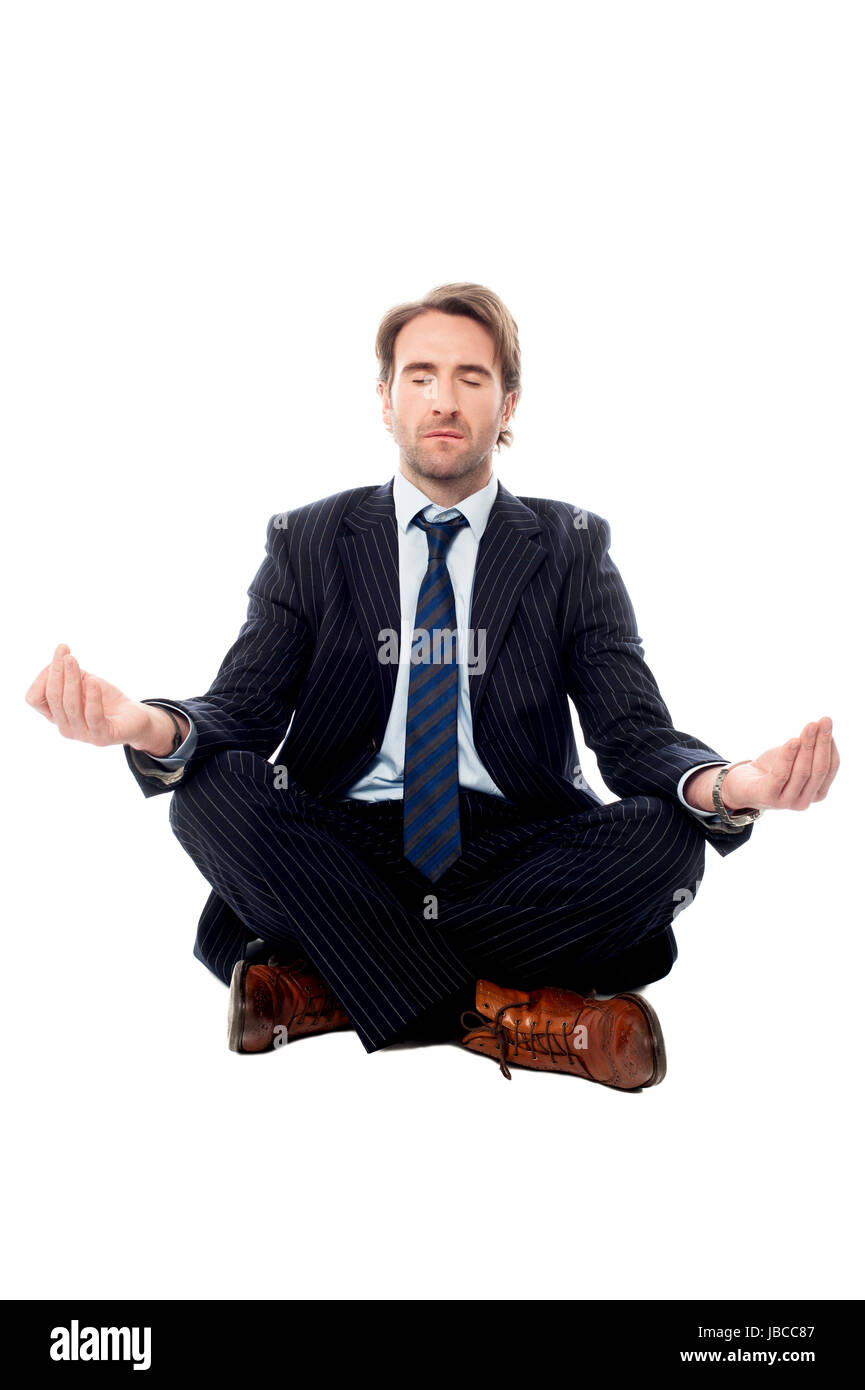 Handsome businessman meditating in lotus posture Stock Photo - Alamy