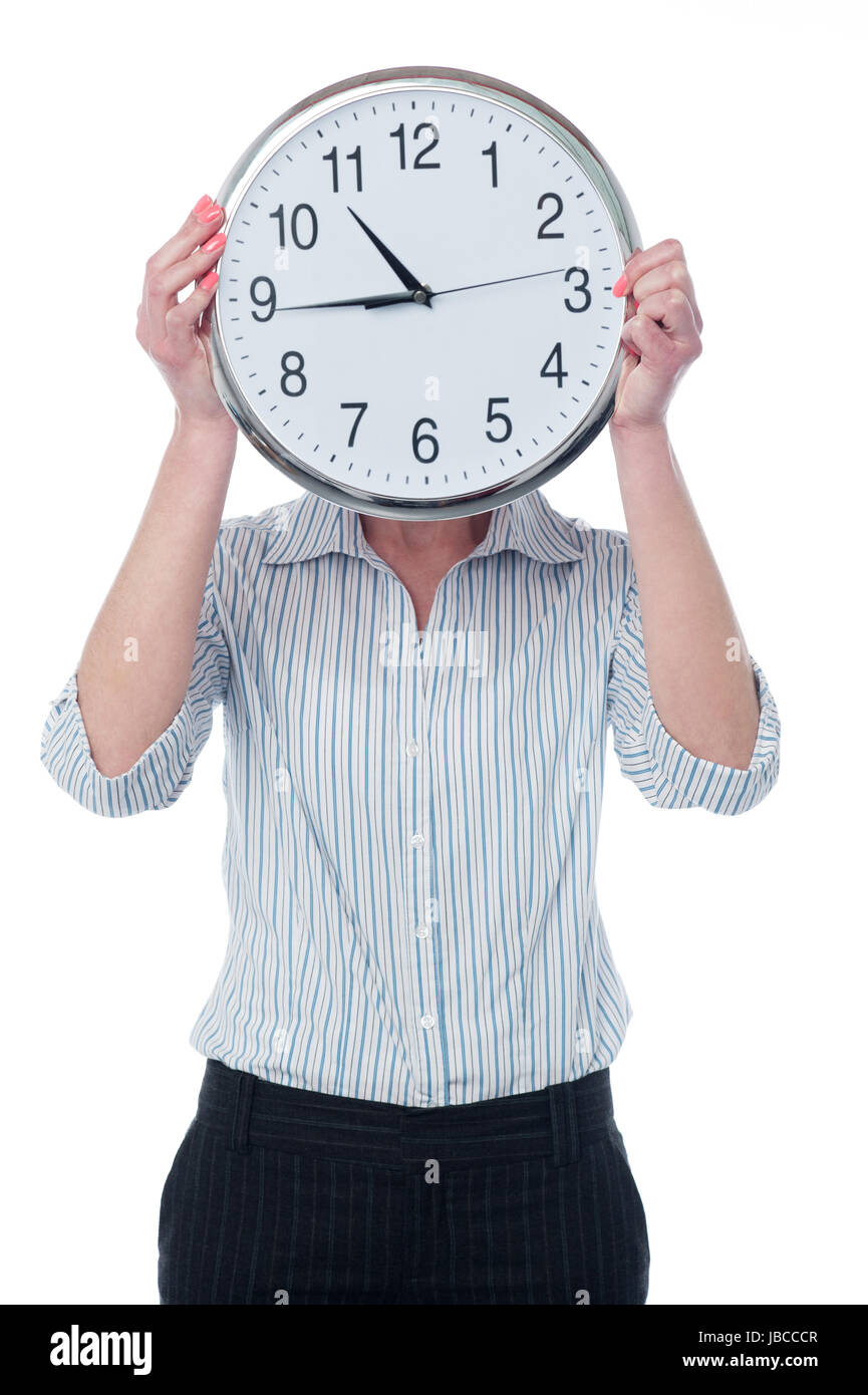 Female holding wall clock in front of her face Stock Photo - Alamy