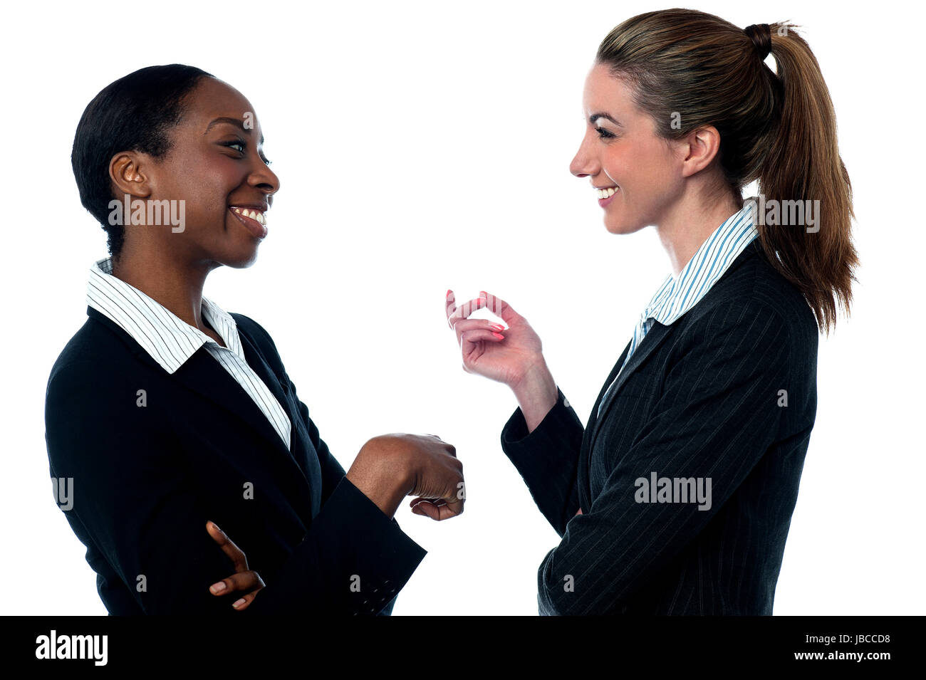 Two female employees talking casually Stock Photo - Alamy