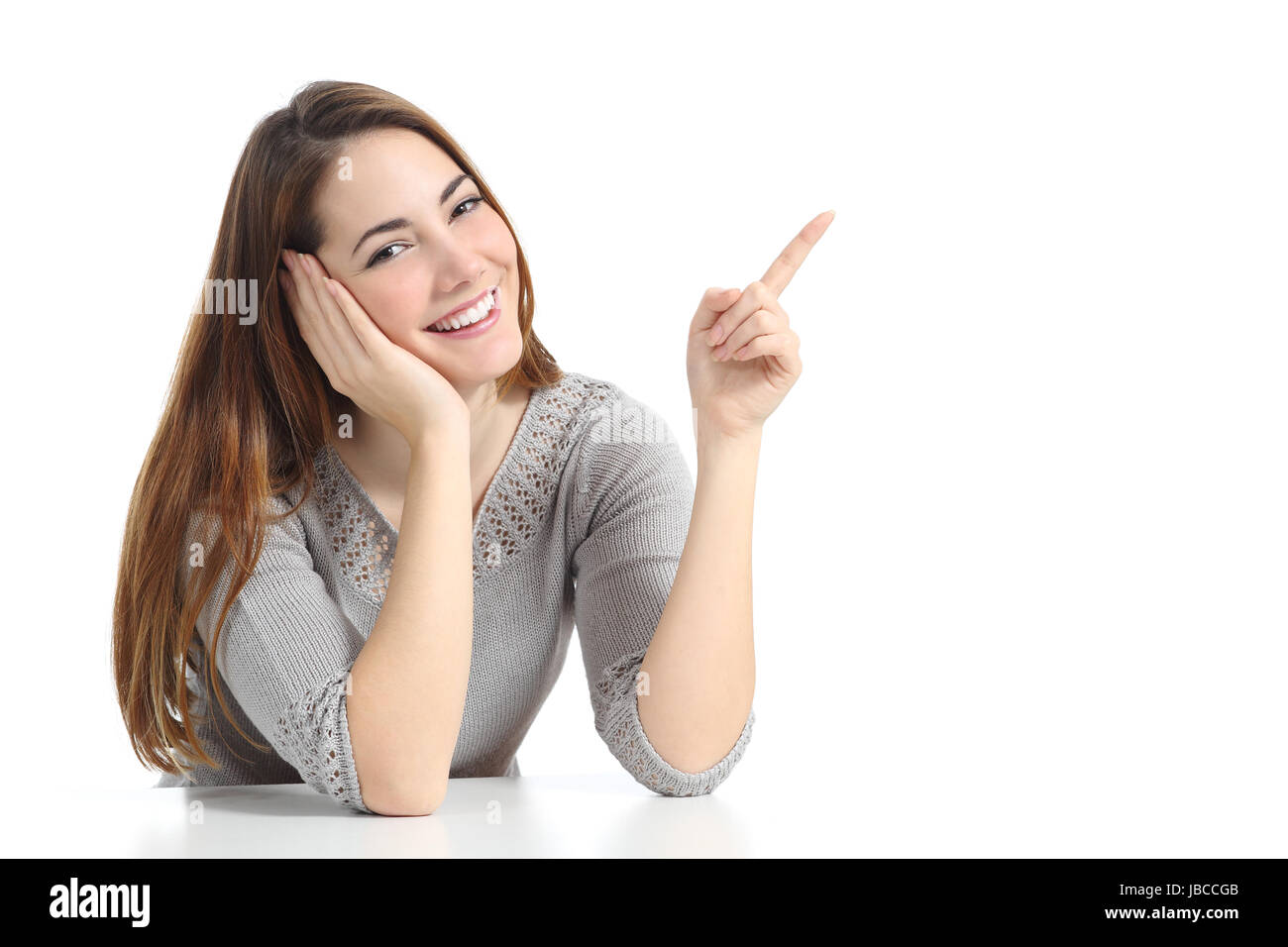 Happy woman pointing and presenting at side looking at camera isolated ...