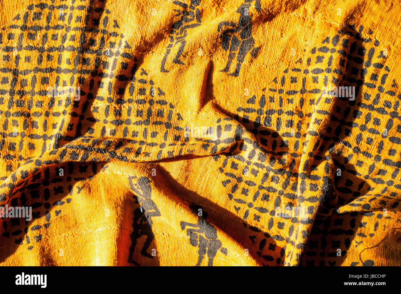 Hand-woven textile with figures from Ghana in studio setting Stock ...