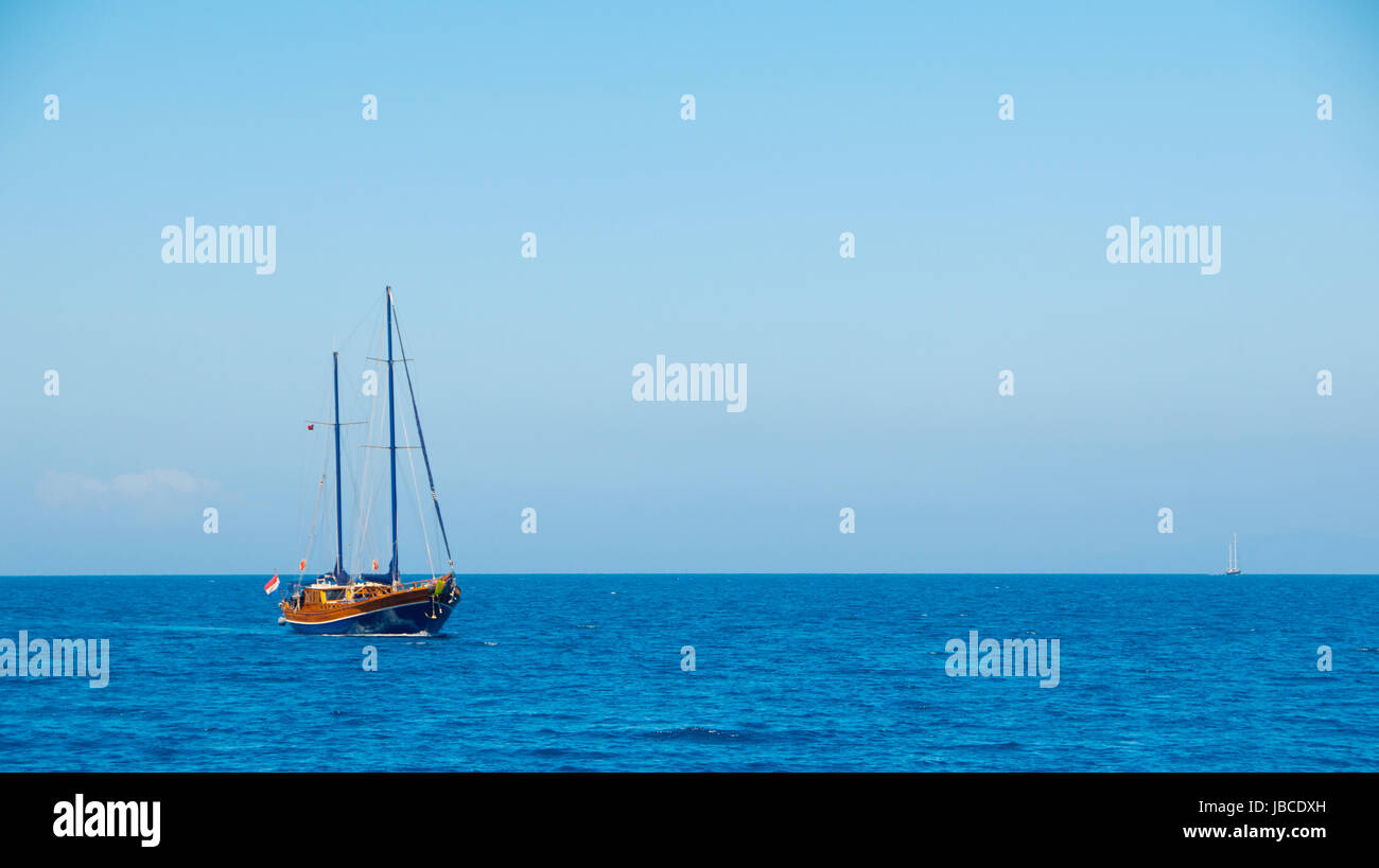 A ship with the sails down on the sea horizon Stock Photo - Alamy