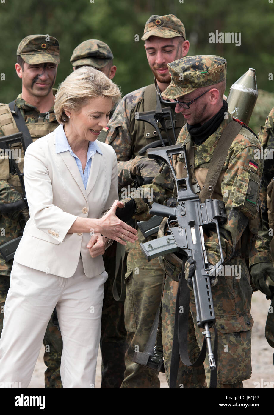 German Defence Minister Ursula von der Leyen (CDU, C) shakes hands with ...