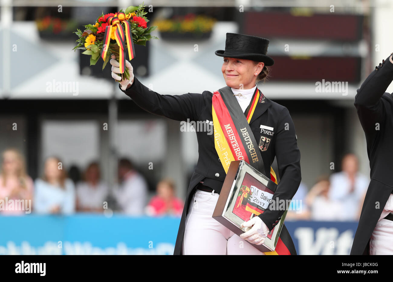 Dressage rider Isabell Werth with a bunch of flowers during the victory ...