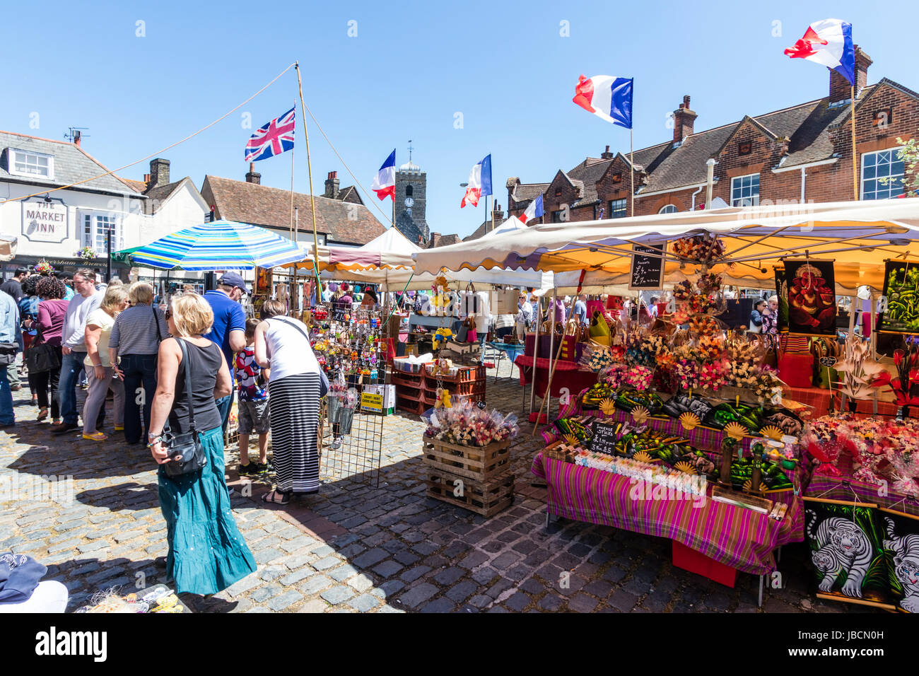 People wandering around busy French market set up at Sandwich town ...