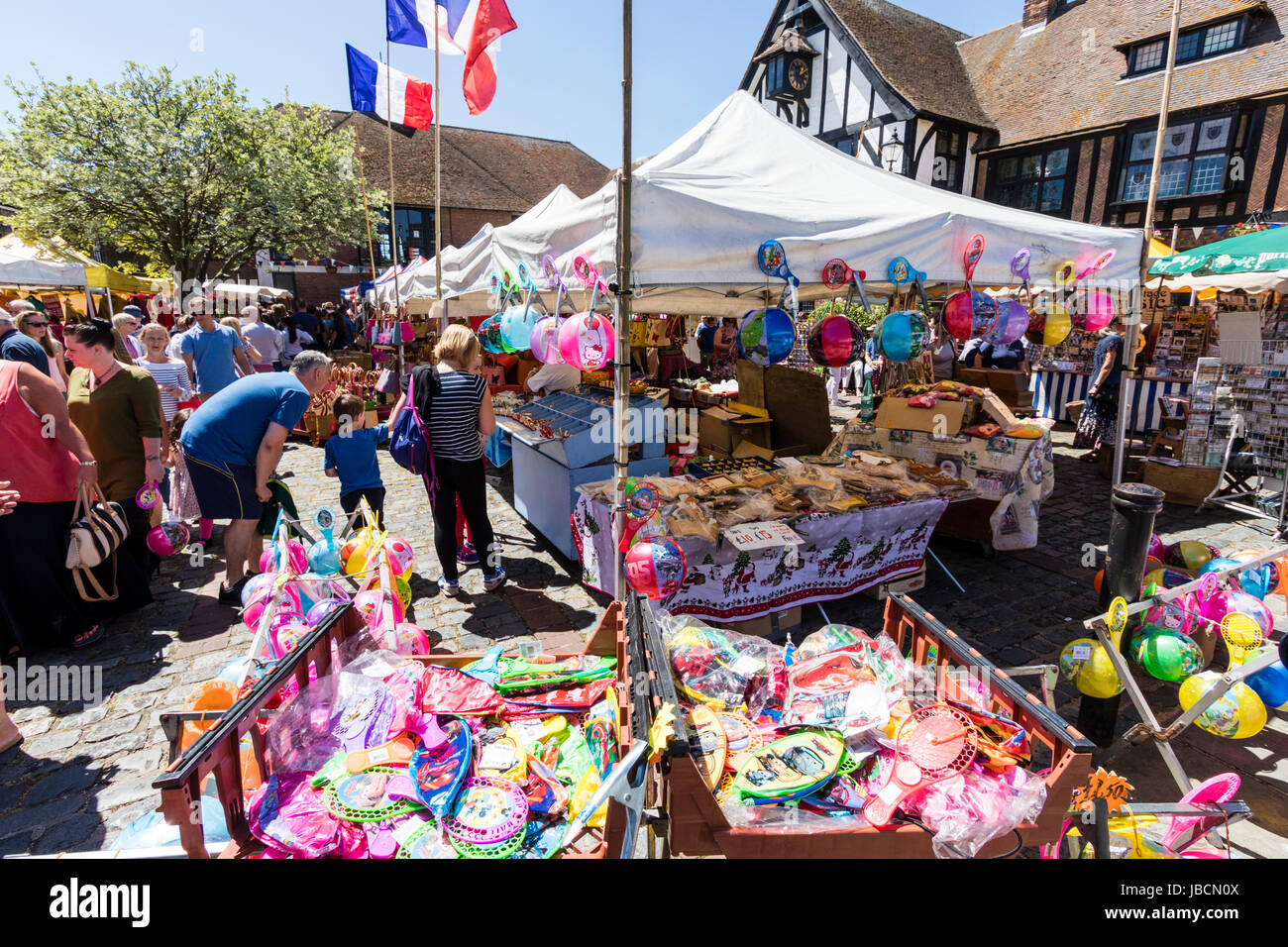 People wandering around busy French market set up at Sandwich town ...