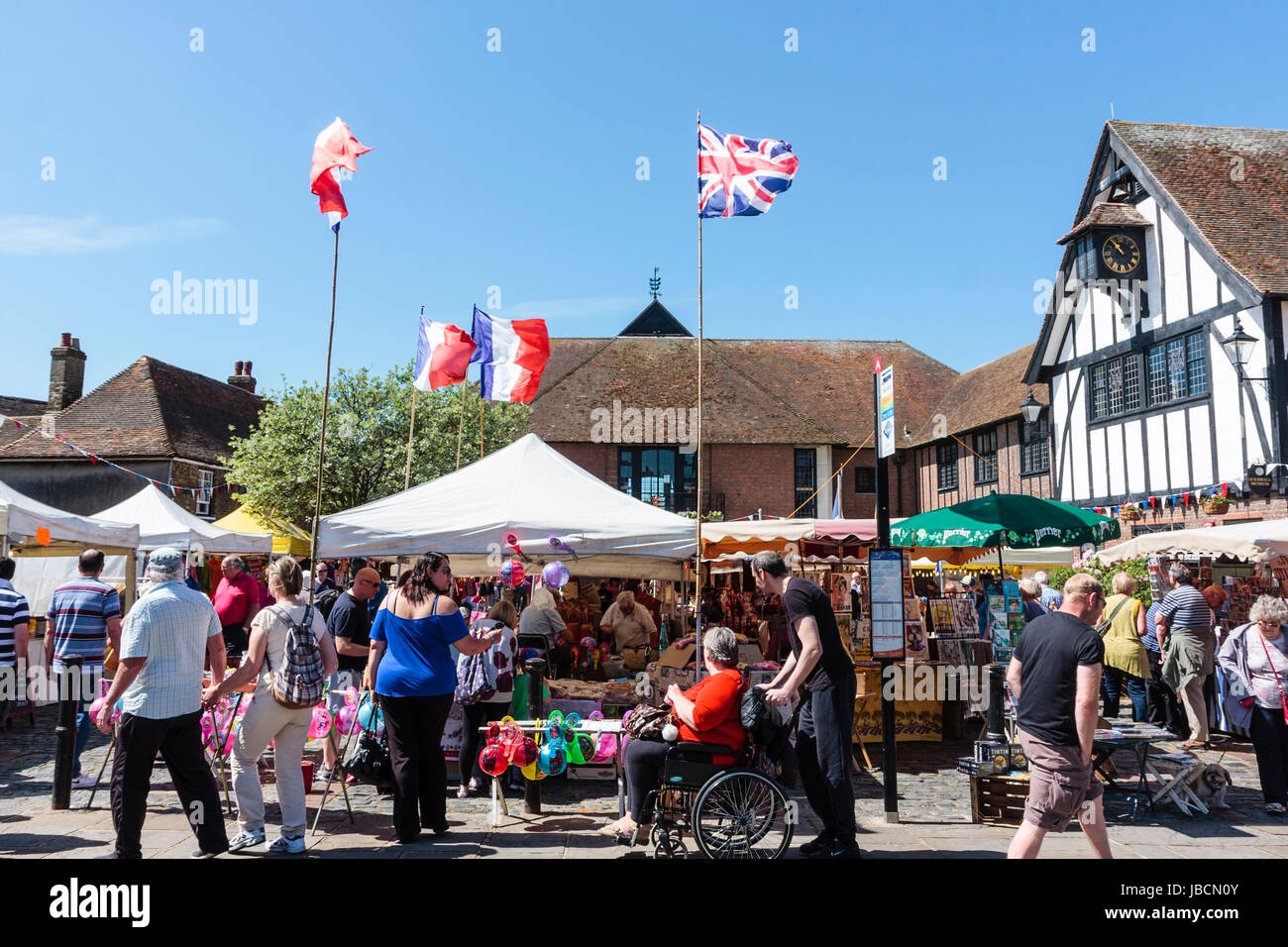 French market event outside 15th century guildhall at English town ...