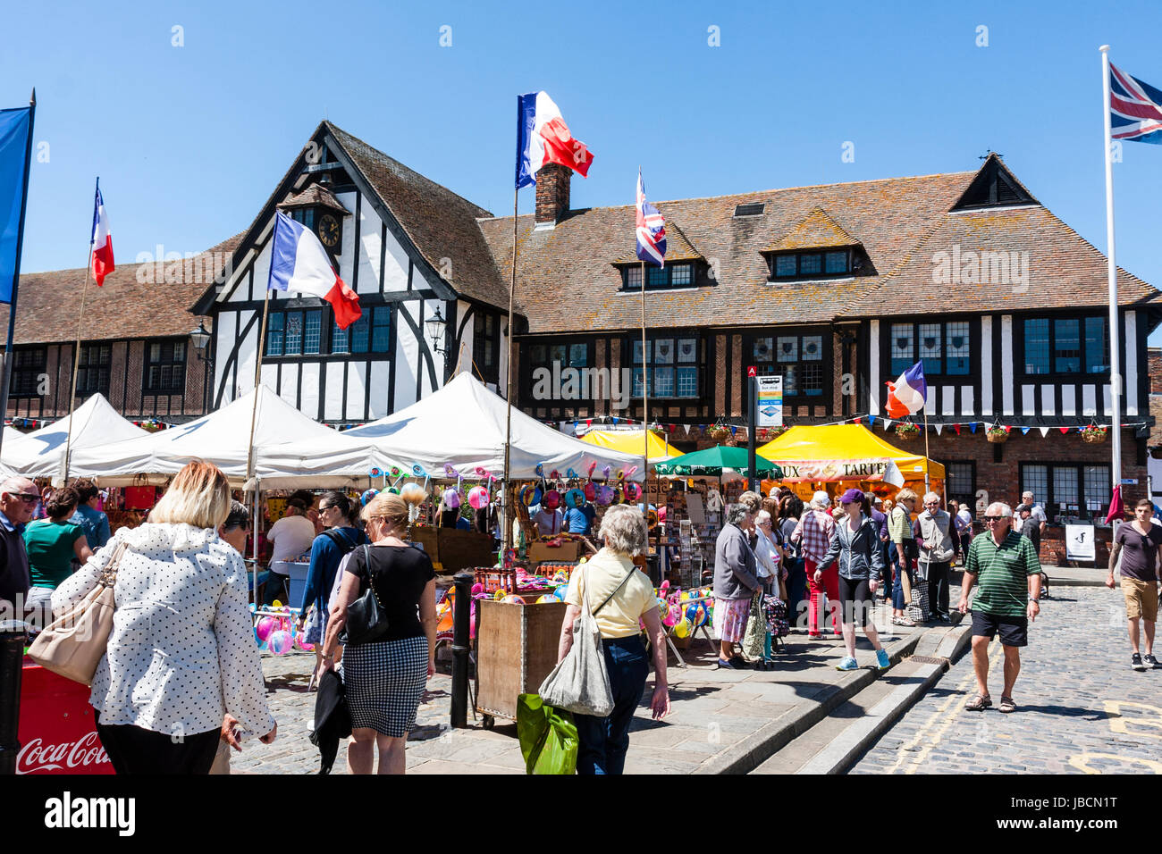French market event outside 15th century guildhall at English town ...