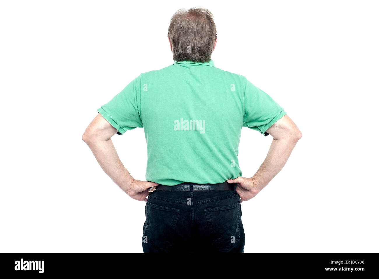 Back pose of elderly guy with hands on his waist. Facing opposite side ...