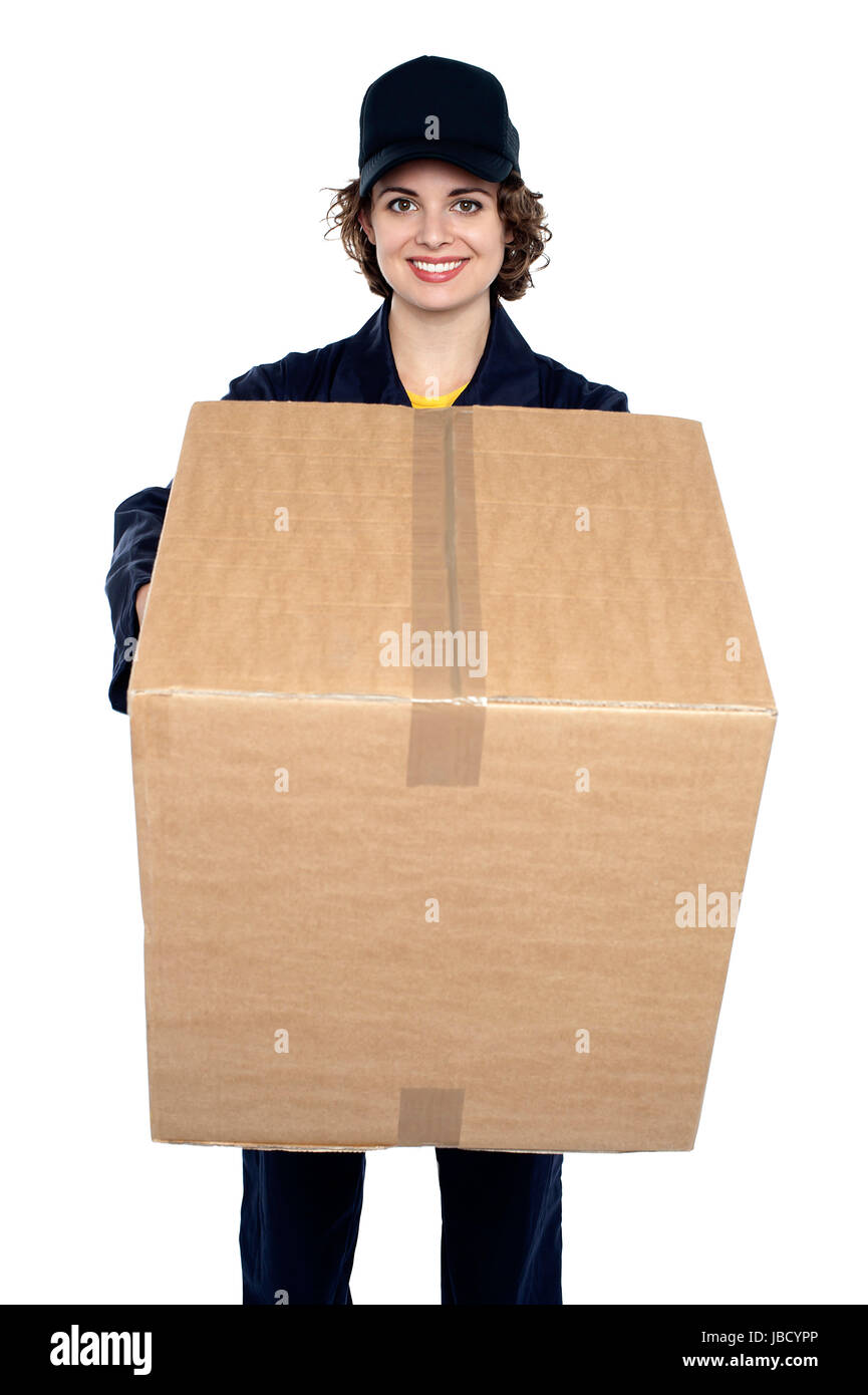 Young delivery woman in uniform displaying a packed cardboard box to ...