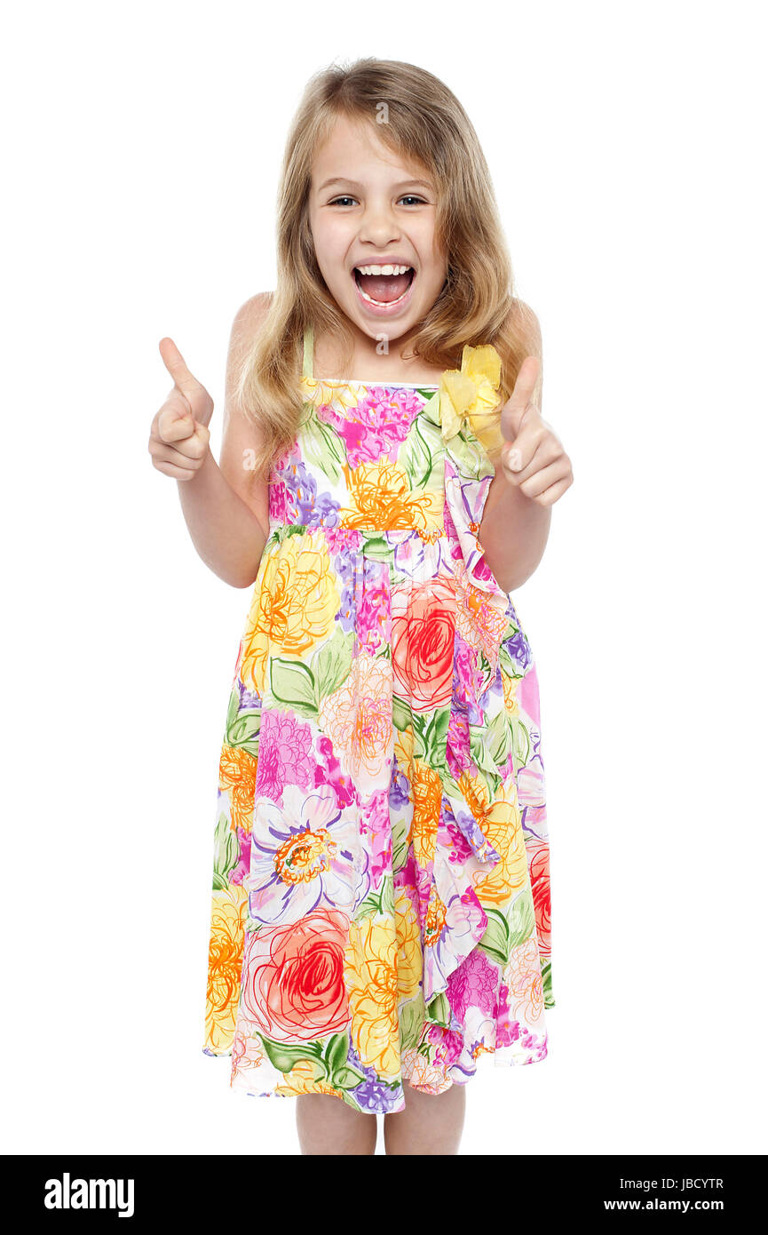 Expression of an excited female child gesturing double thumbs up to the ...